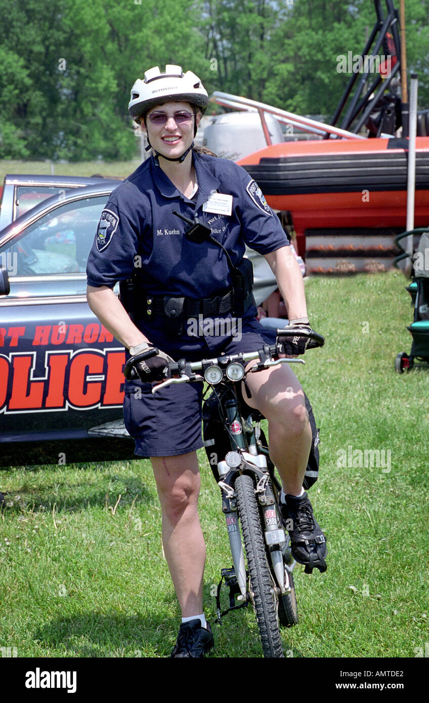 Female police officer patrols park ground on bicycle Stock Photo - Alamy