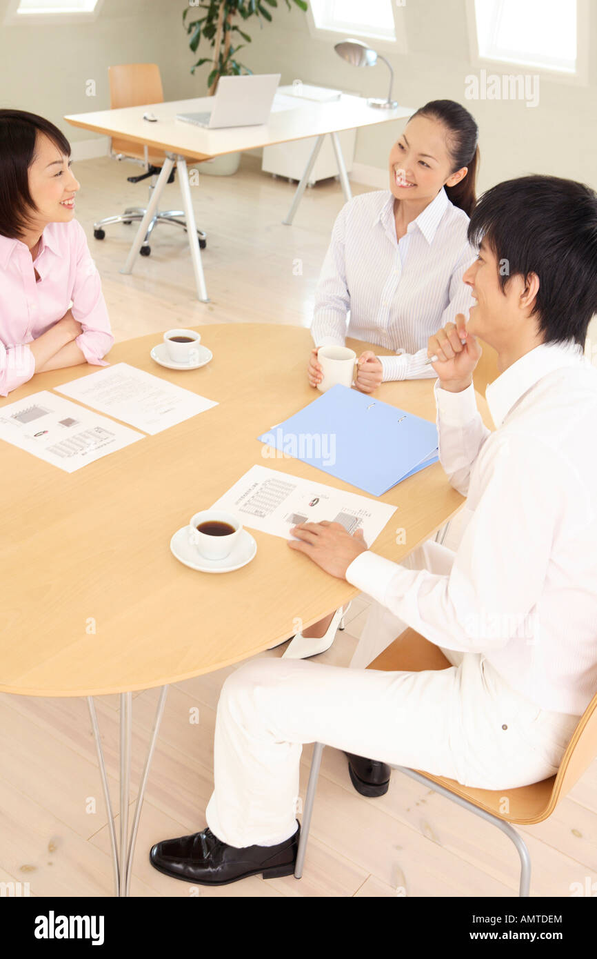 Office workers having a brief meeting Stock Photo - Alamy