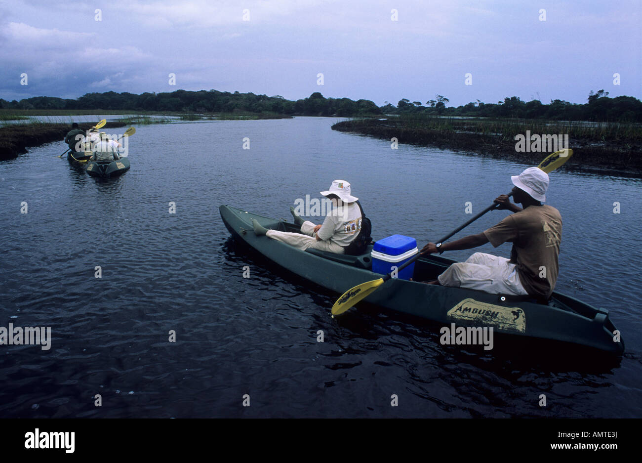 Tourists kayaking along lagoon under cloudy sky Stock Photo - Alamy