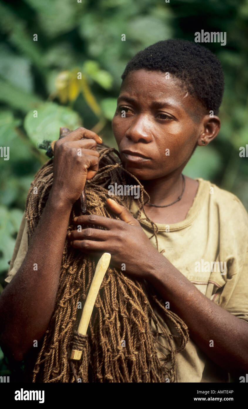 Portrait of pygmy woman with net used for hunting in the forests of ...
