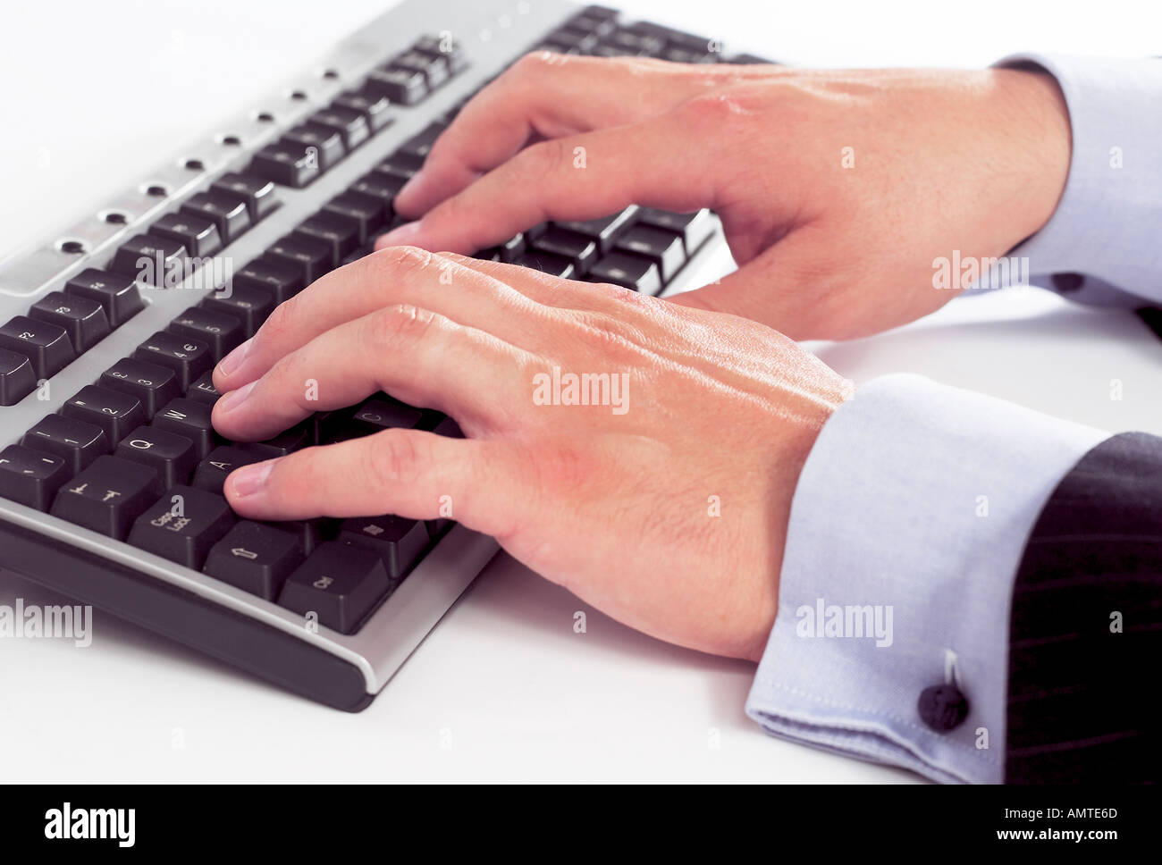 Mans hands operating a computer keyboard Stock Photo - Alamy