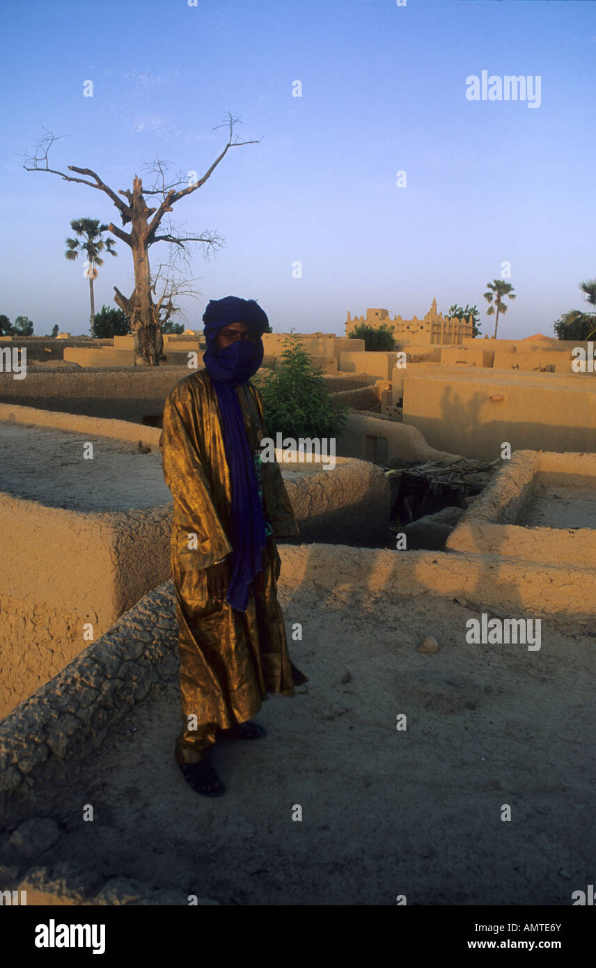 Bambara man standing on rooftop overlooking village Stock Photo - Alamy