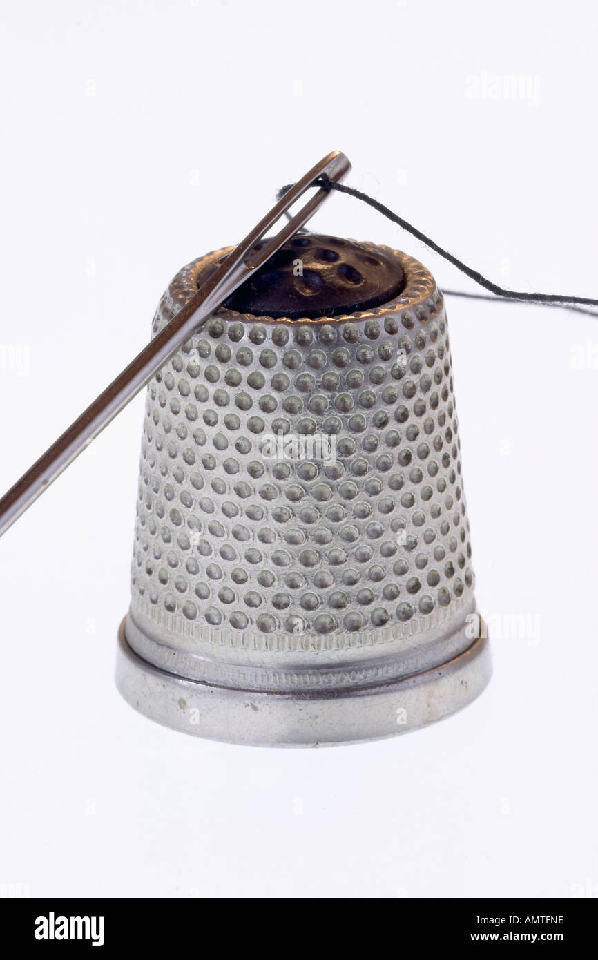 Thimble, sewing needle and thread Stock Photo - Alamy