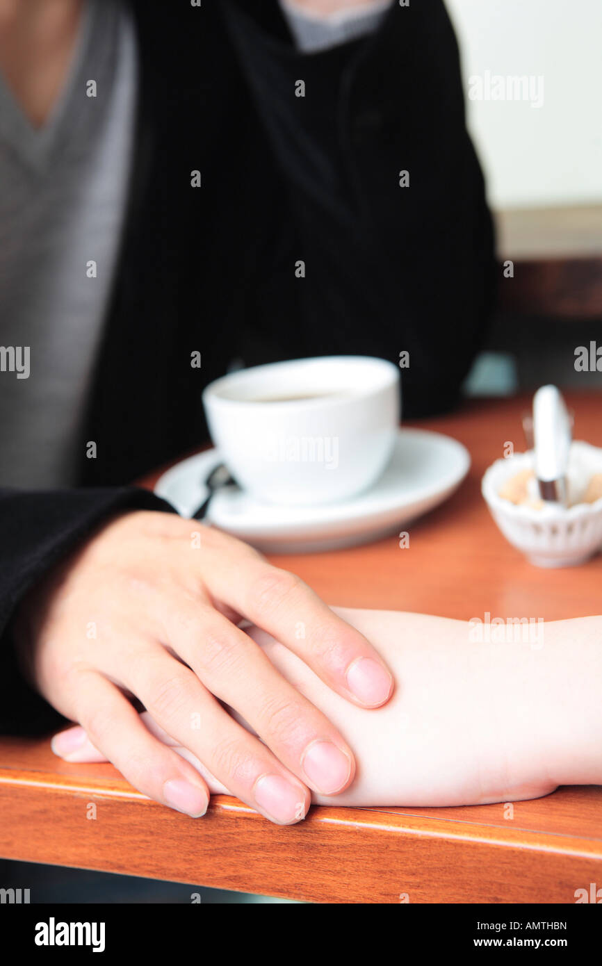 Hands on the table Stock Photo - Alamy