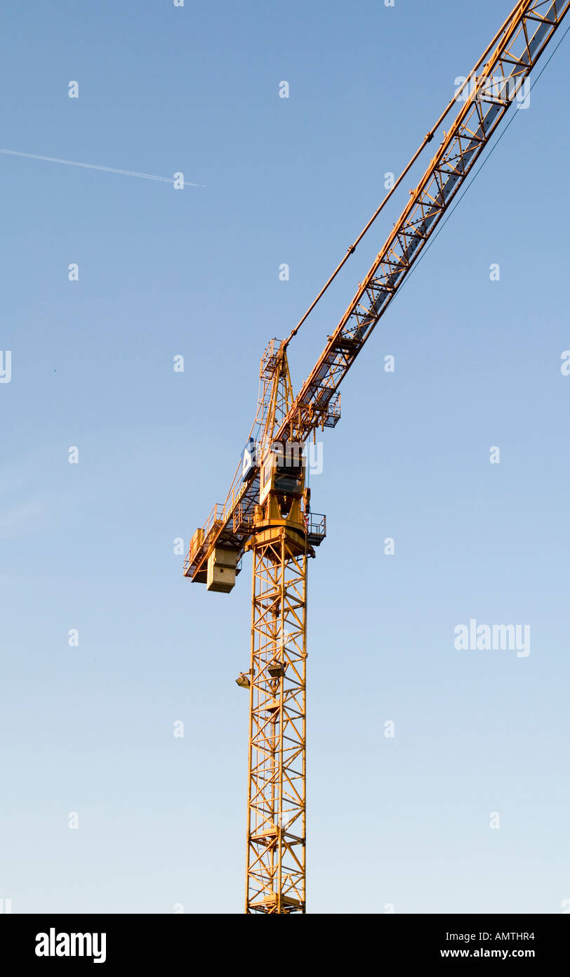 Crane with airplane in the sky Stock Photo - Alamy