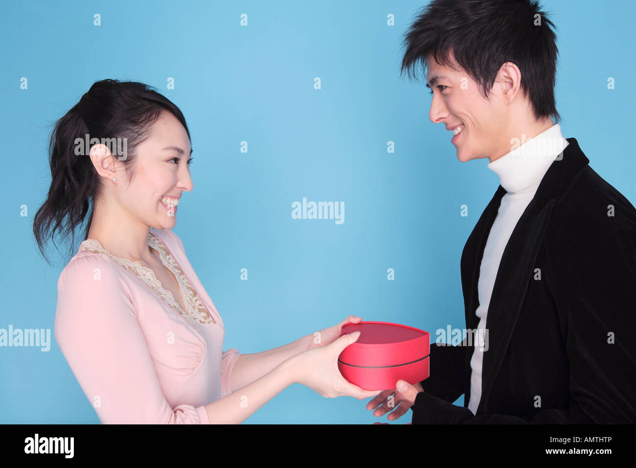 Woman handing a gift to lover Stock Photo - Alamy