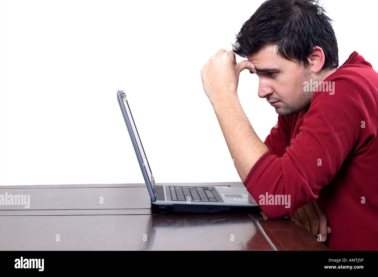 Confused man using laptop Stock Photo - Alamy