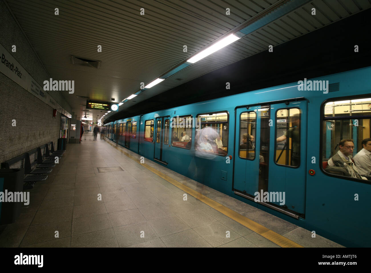 Arriving train and boarding passengers of the underground line U4 in a ...