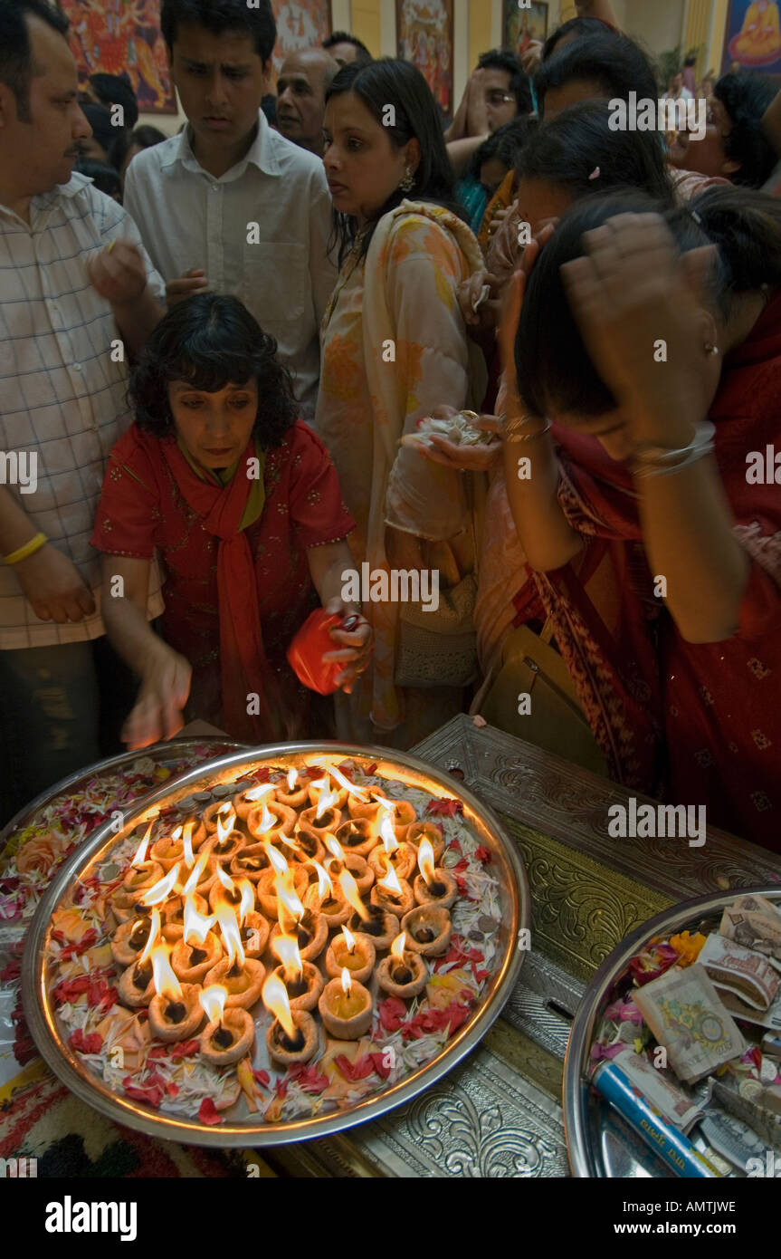 Worshippers in Hindu Temple presenting offerings during ceremony Stock ...