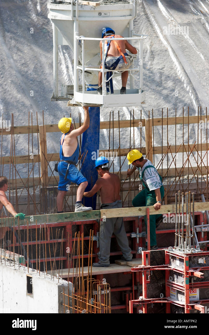 Construction worker with concrete packaging on a building site Stock ...