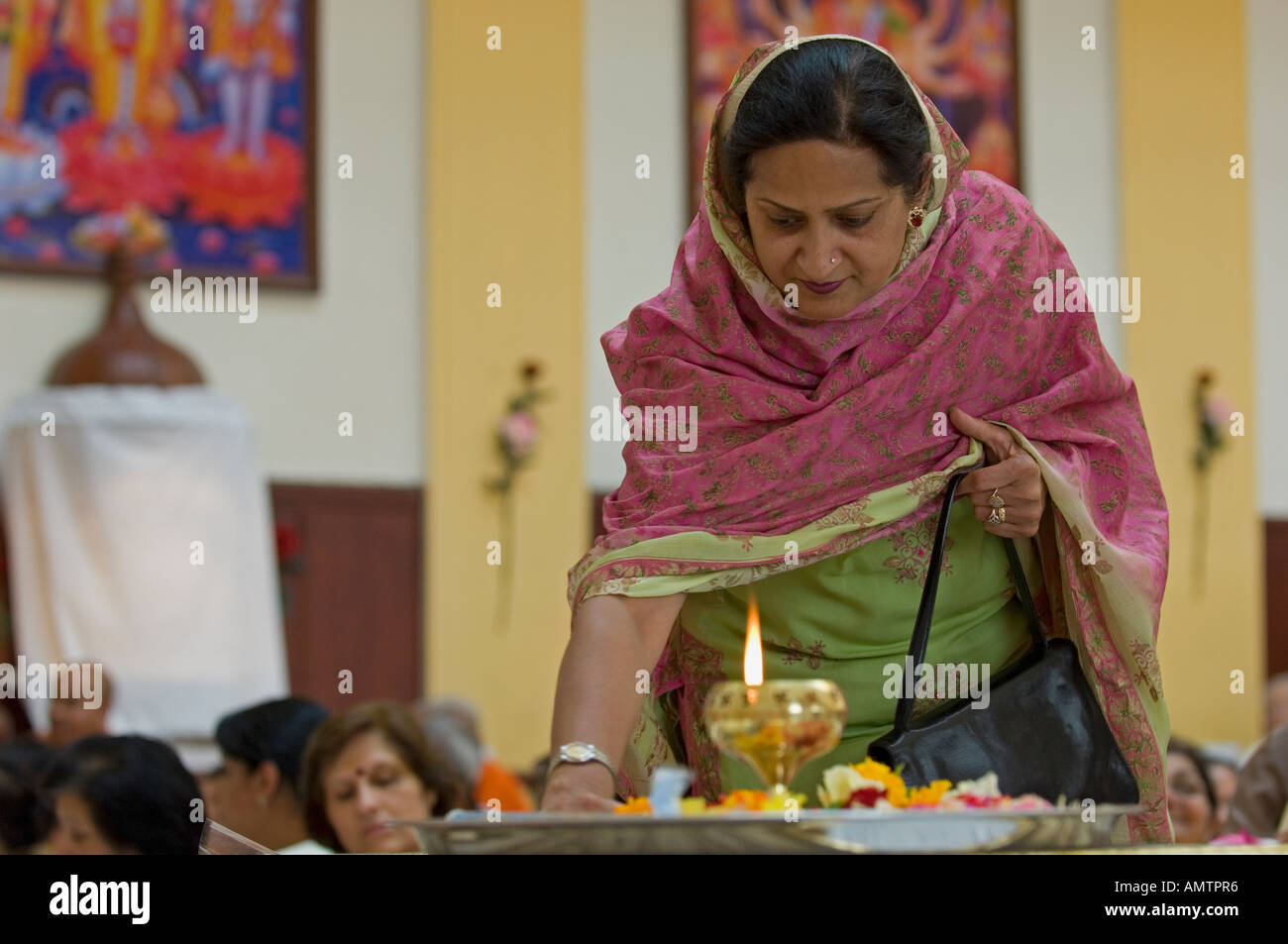 Devotee and offerings at the consecration ceremony of an Hindu temple ...