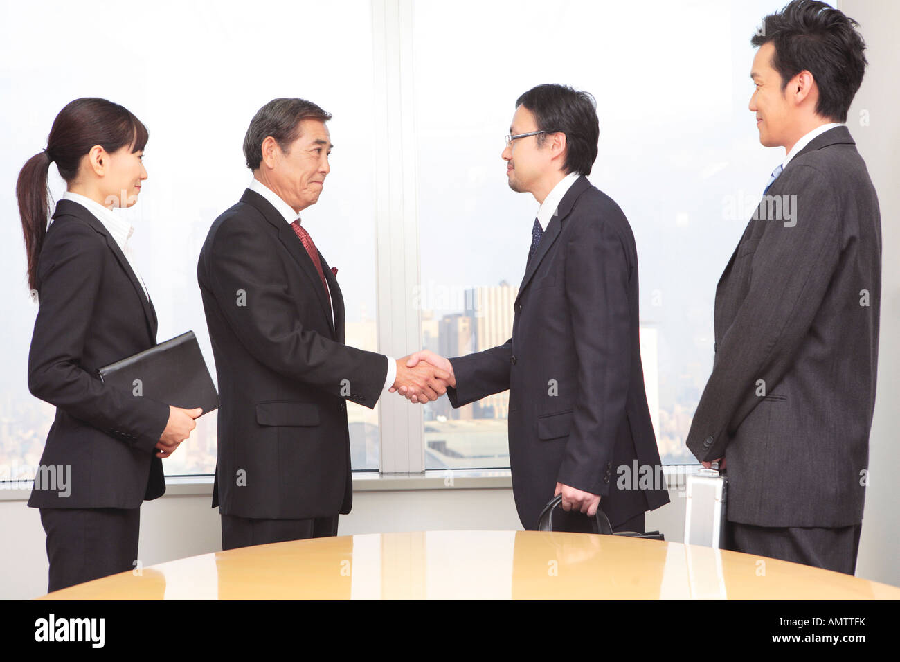 Japanese office workers shaking hands Stock Photo - Alamy