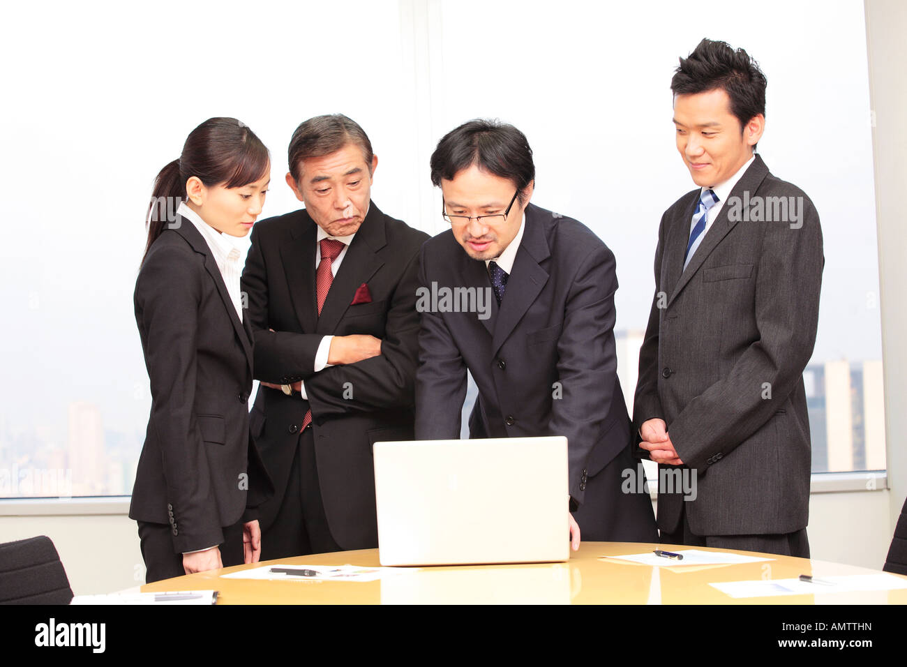 Japanese office workers having a brief meeting Stock Photo - Alamy