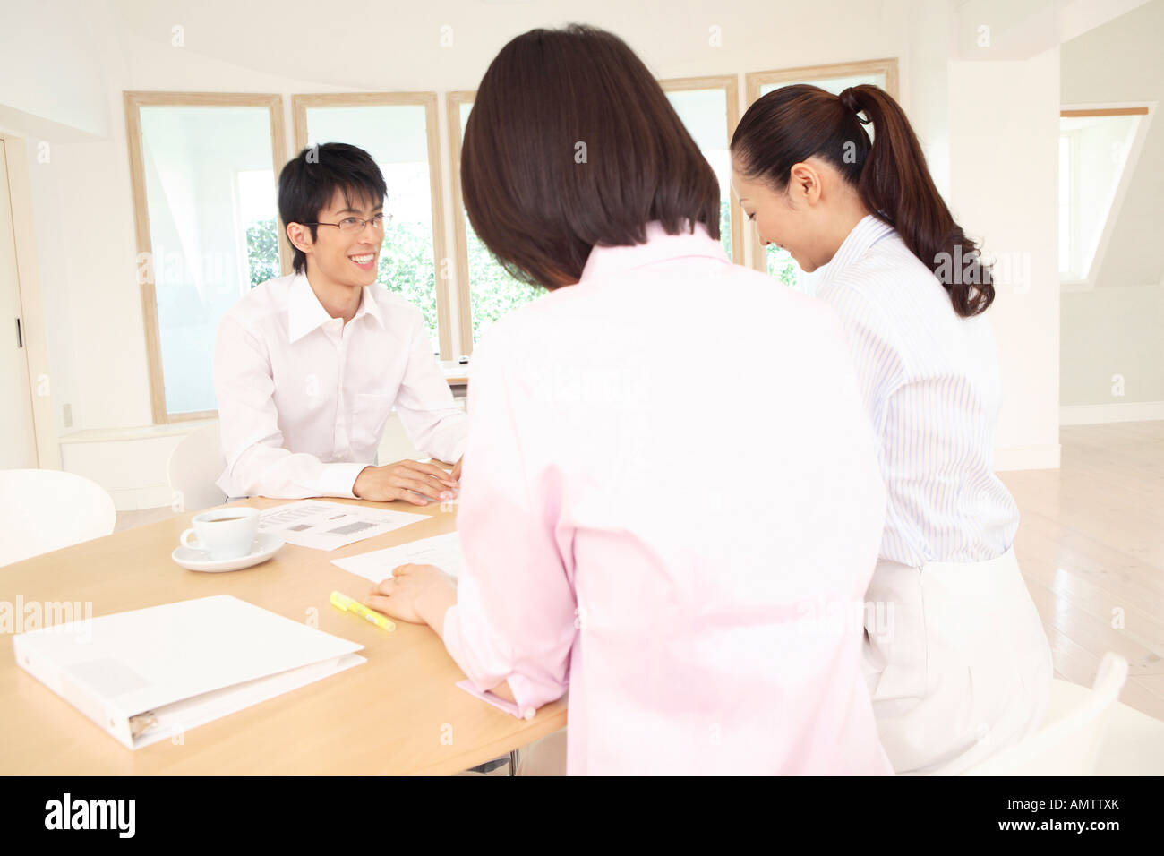Office workers having a brief meeting Stock Photo - Alamy
