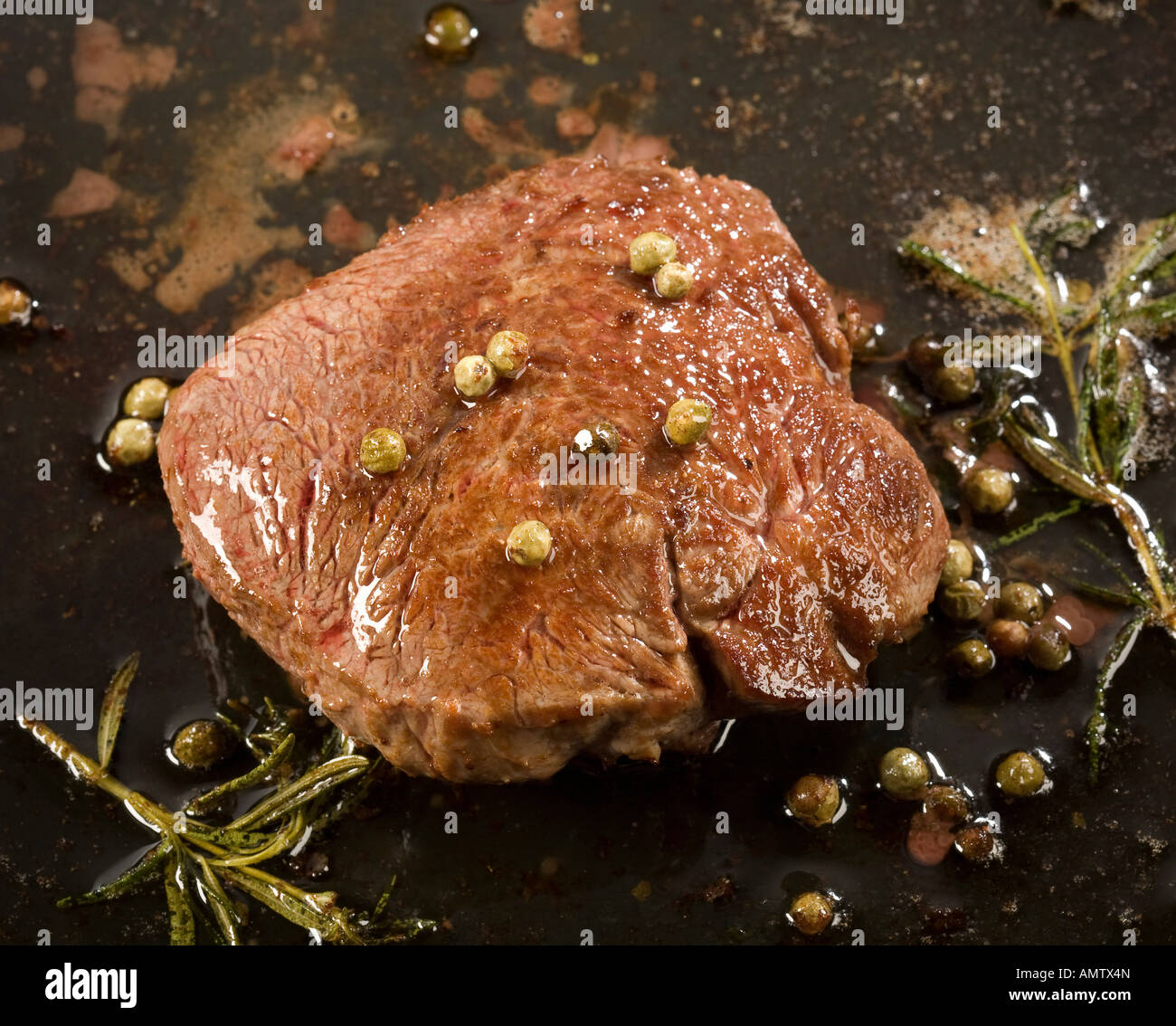 Beef steak on a frying pan Stock Photo - Alamy