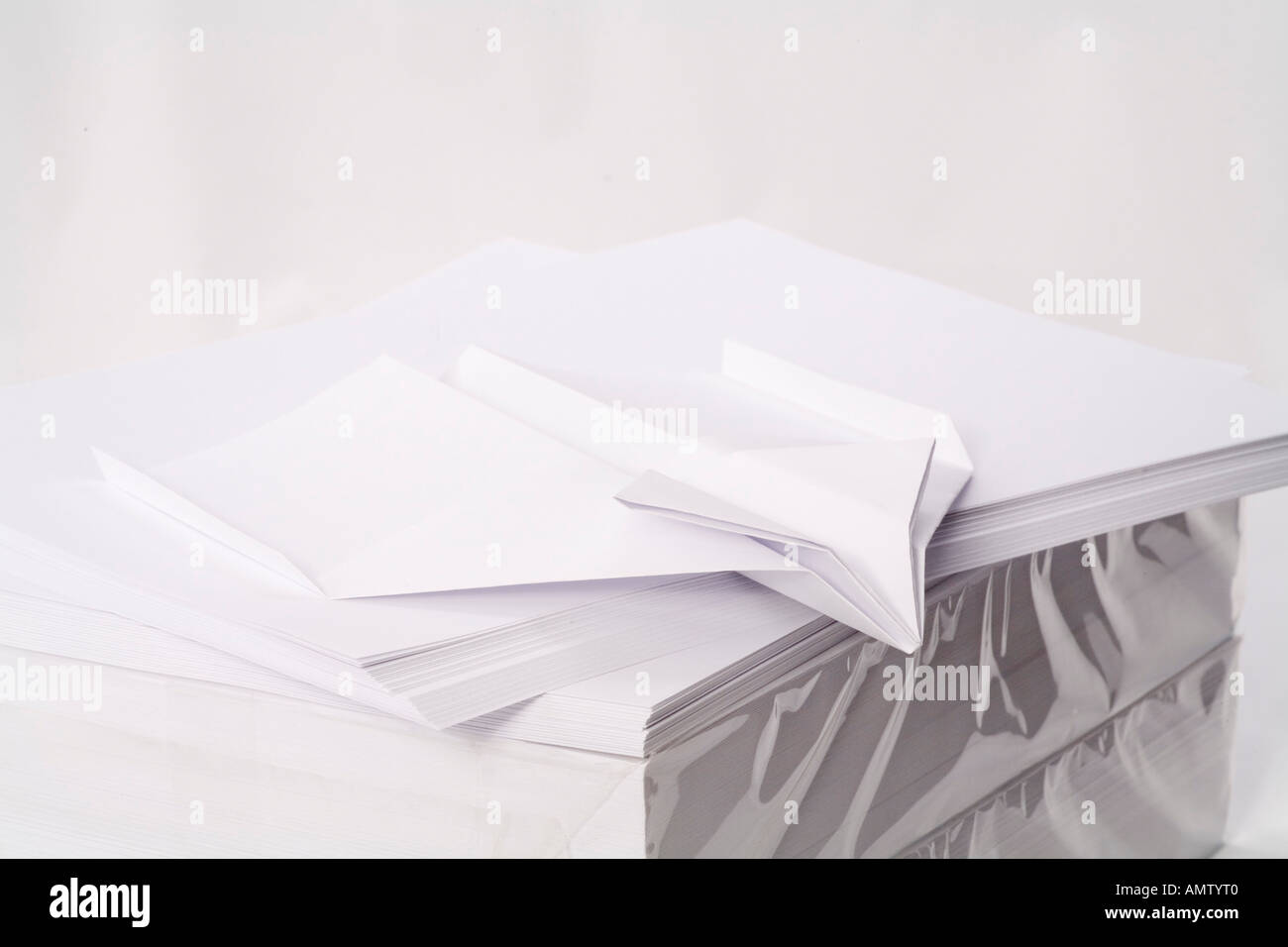 Paper plane with more paper Stock Photo - Alamy