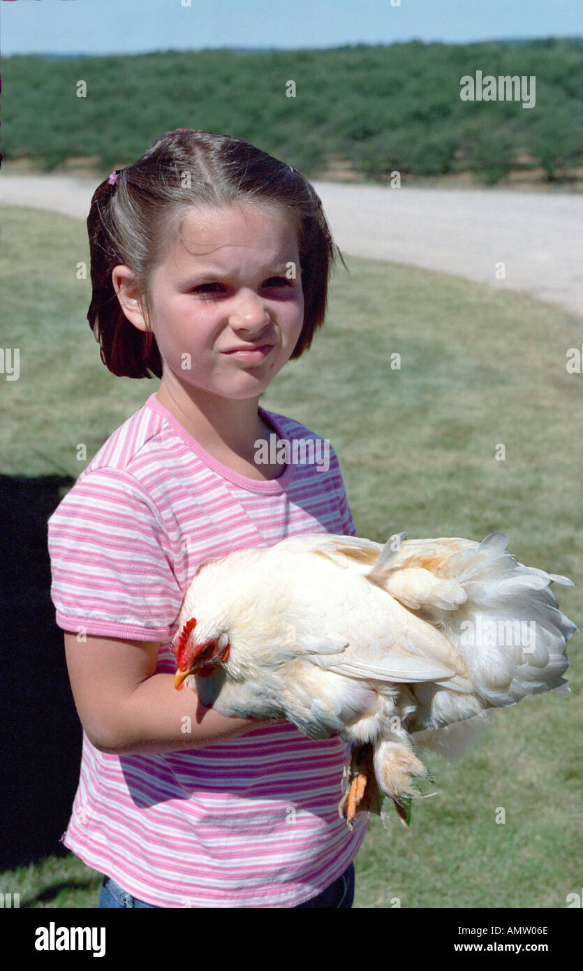 Female child with pet chicken Stock Photo - Alamy
