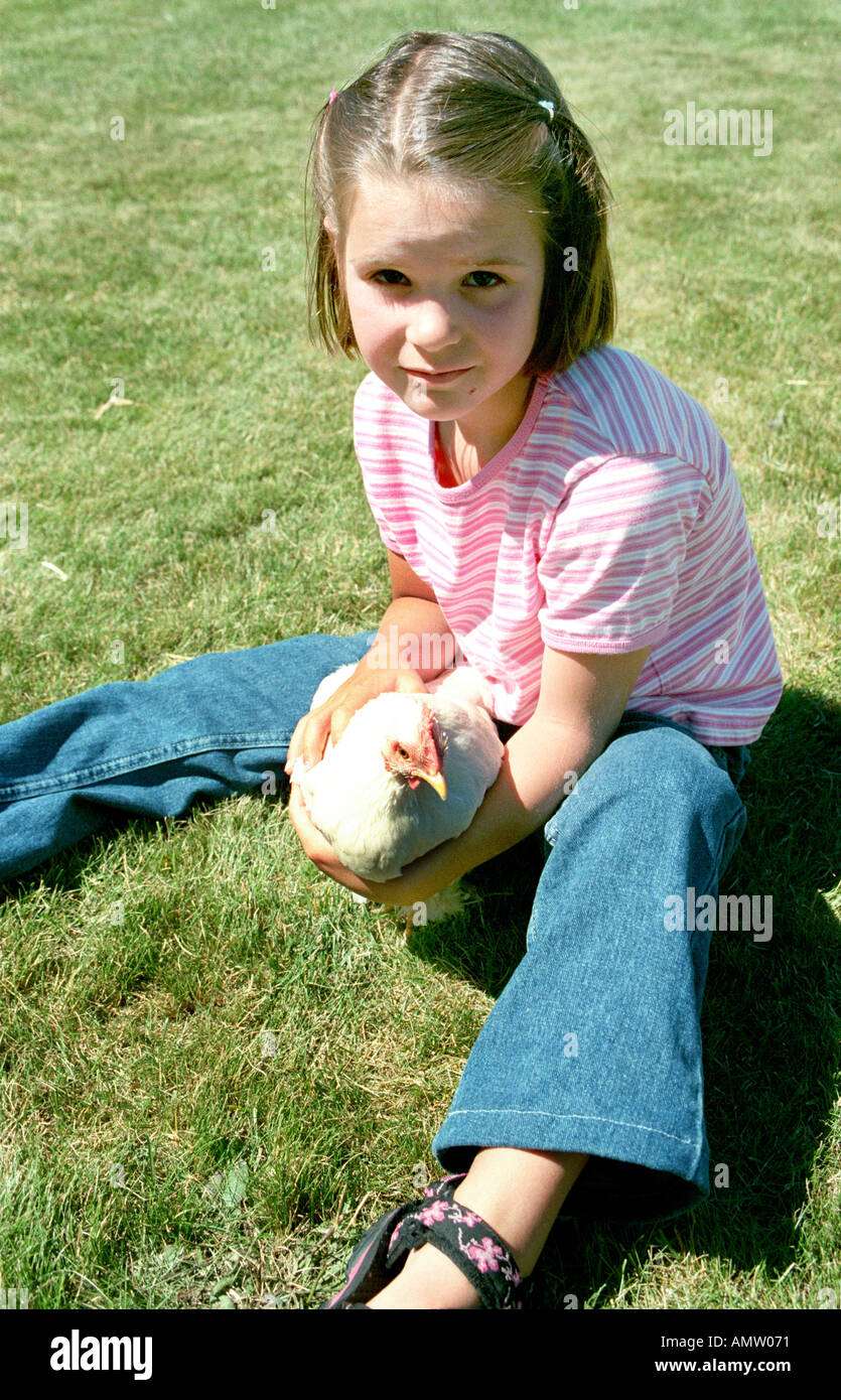 Female child with pet chicken Stock Photo - Alamy