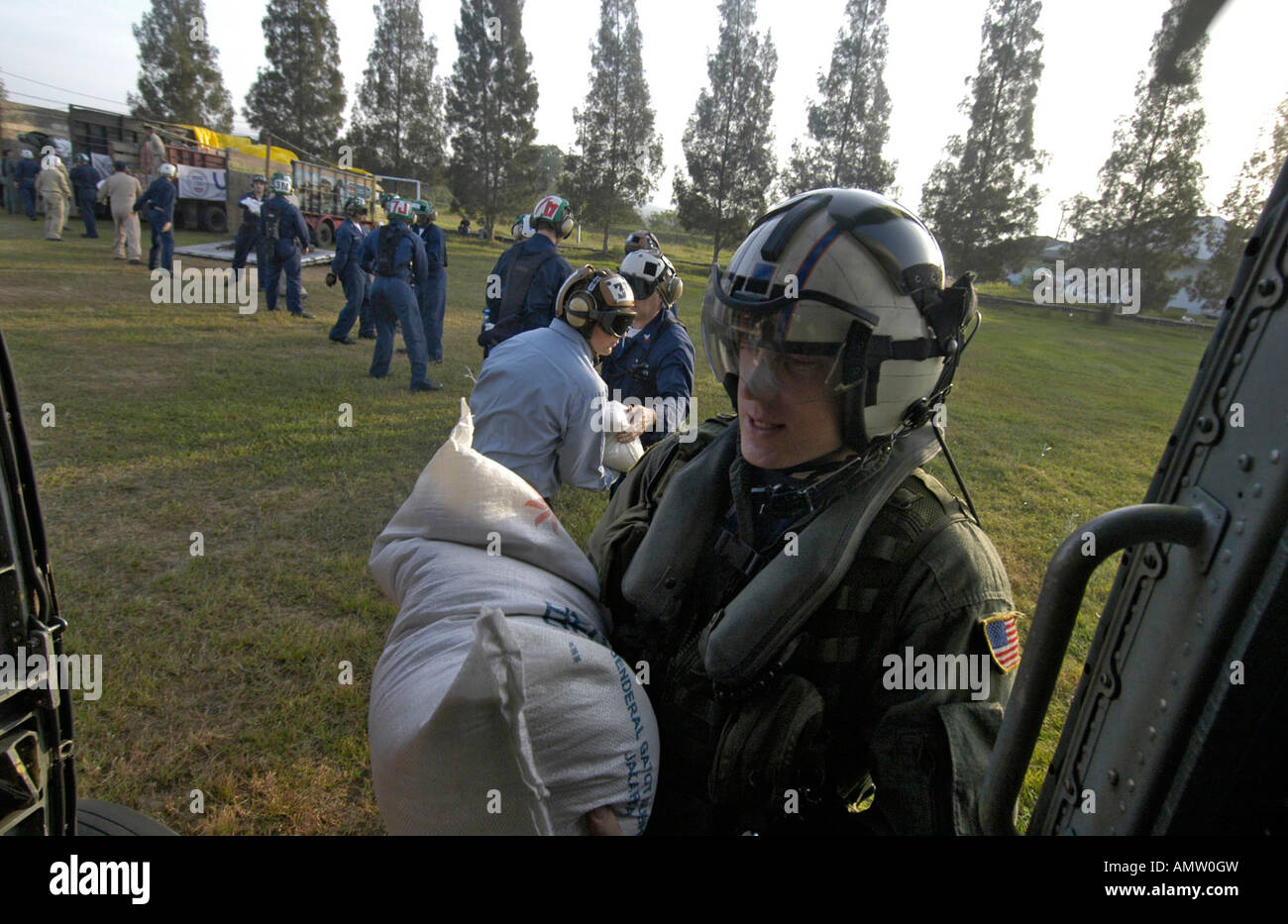 Navy Airman Cory Merritt loads rice into a Seahawk HH 60 H helecopter ...