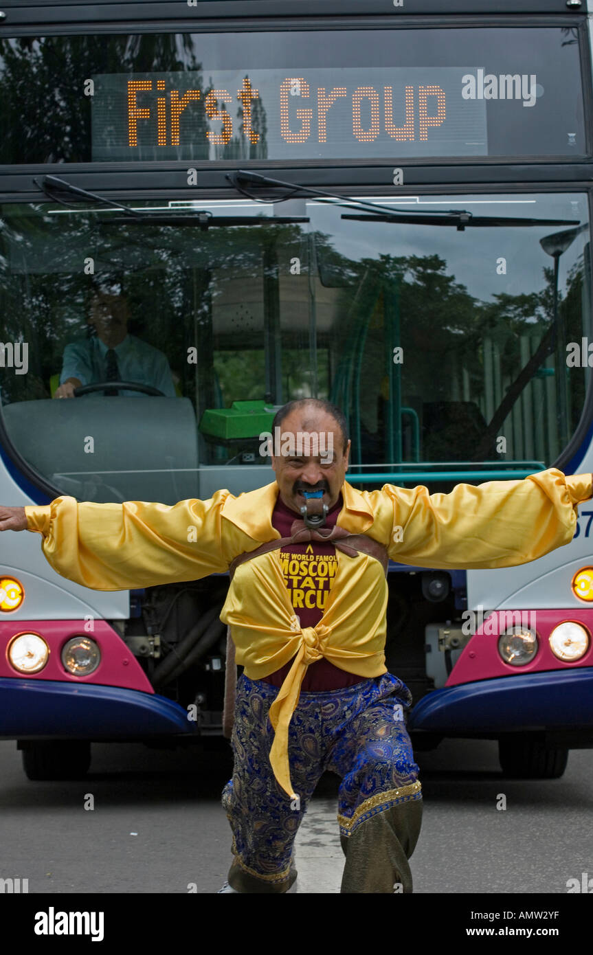 Moscow State Circus strongman towing a double decker bus with his teeth ...