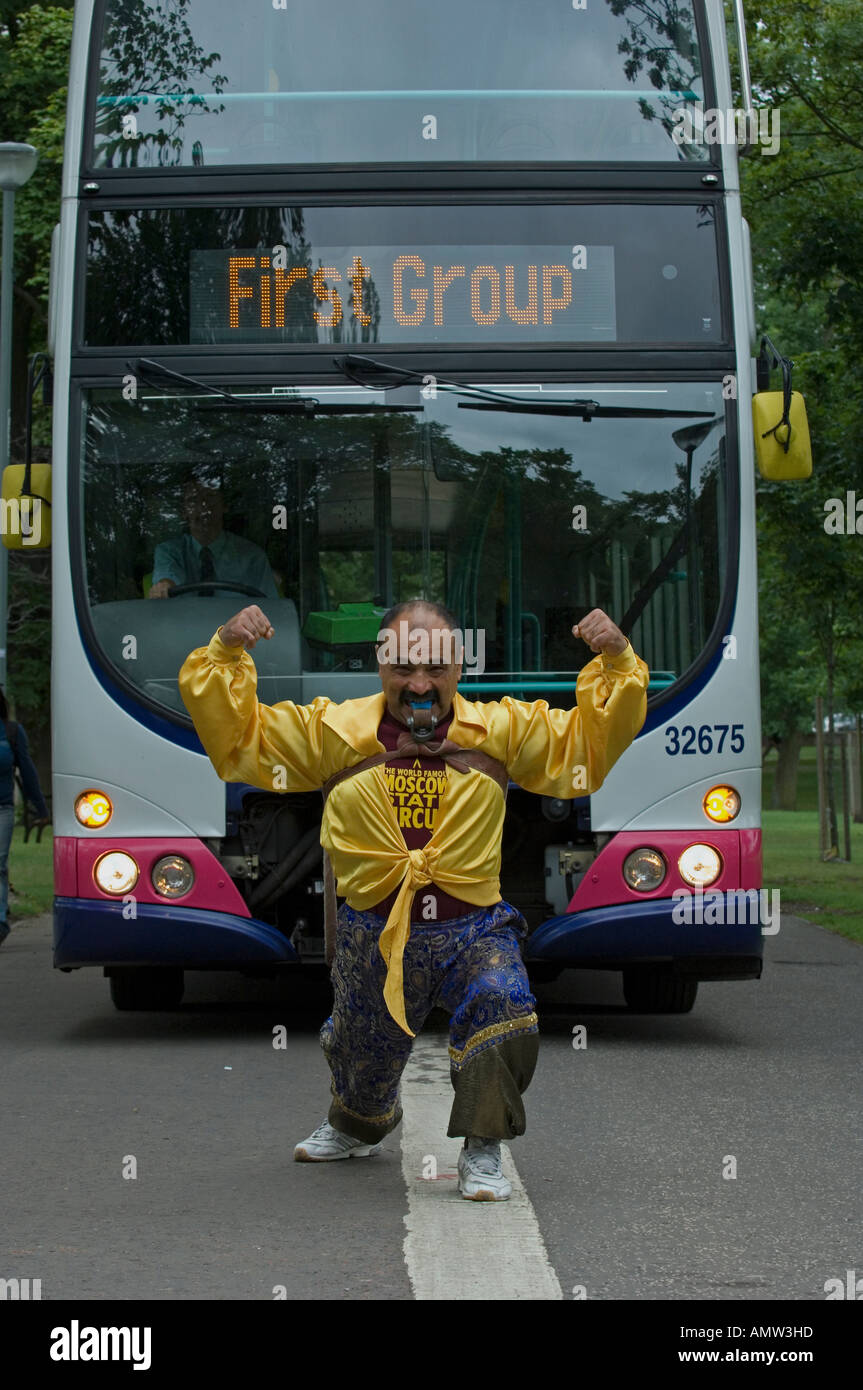 Moscow State Circus strongman towing a double decker bus with his teeth ...