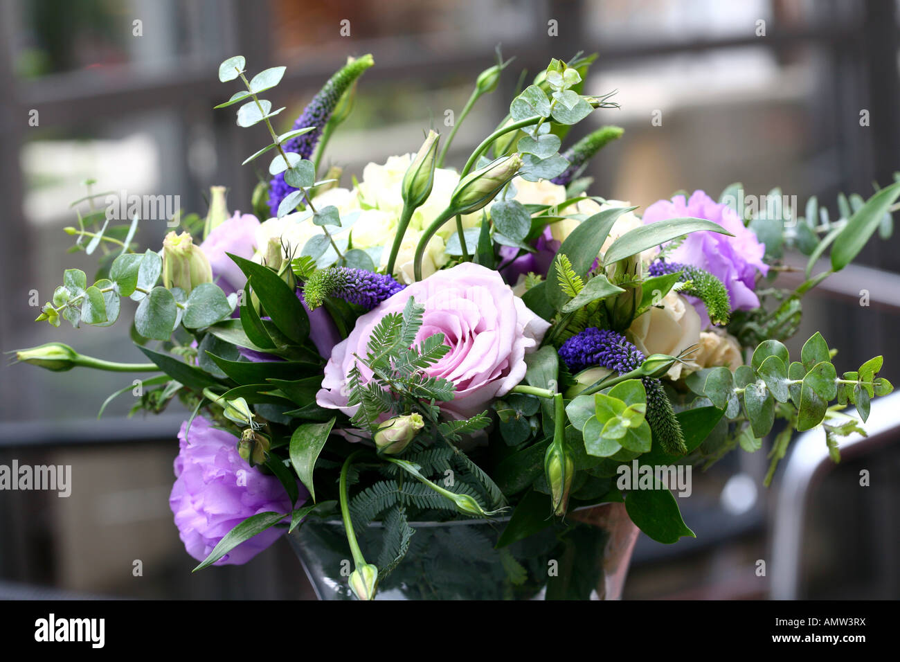 Floral display with purple roses and greenery Stock Photo - Alamy