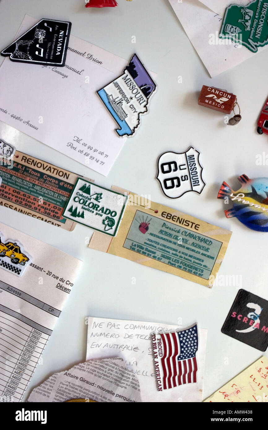 Kitchen fridge with a variety of post it and papers and fridge magnets ...