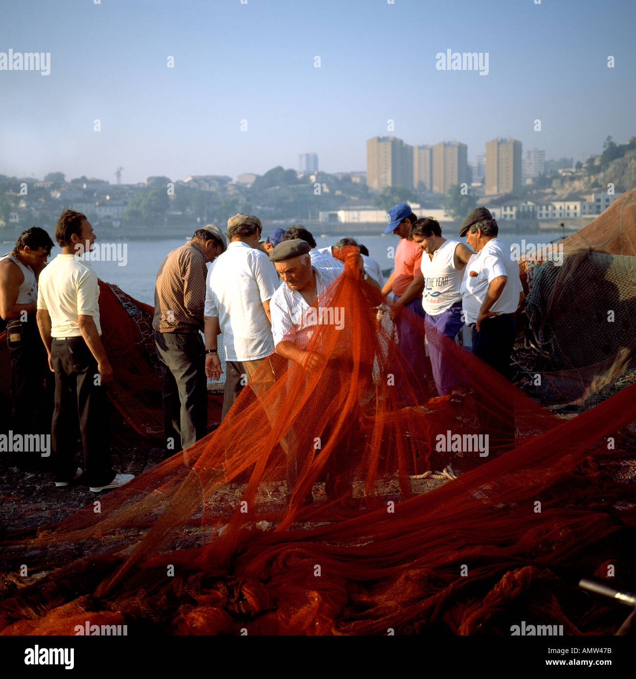 PORTUGAL PORTO AFURADA DISTRICT FISHERMEN SORTING FISHING NETS ON DOURO ...