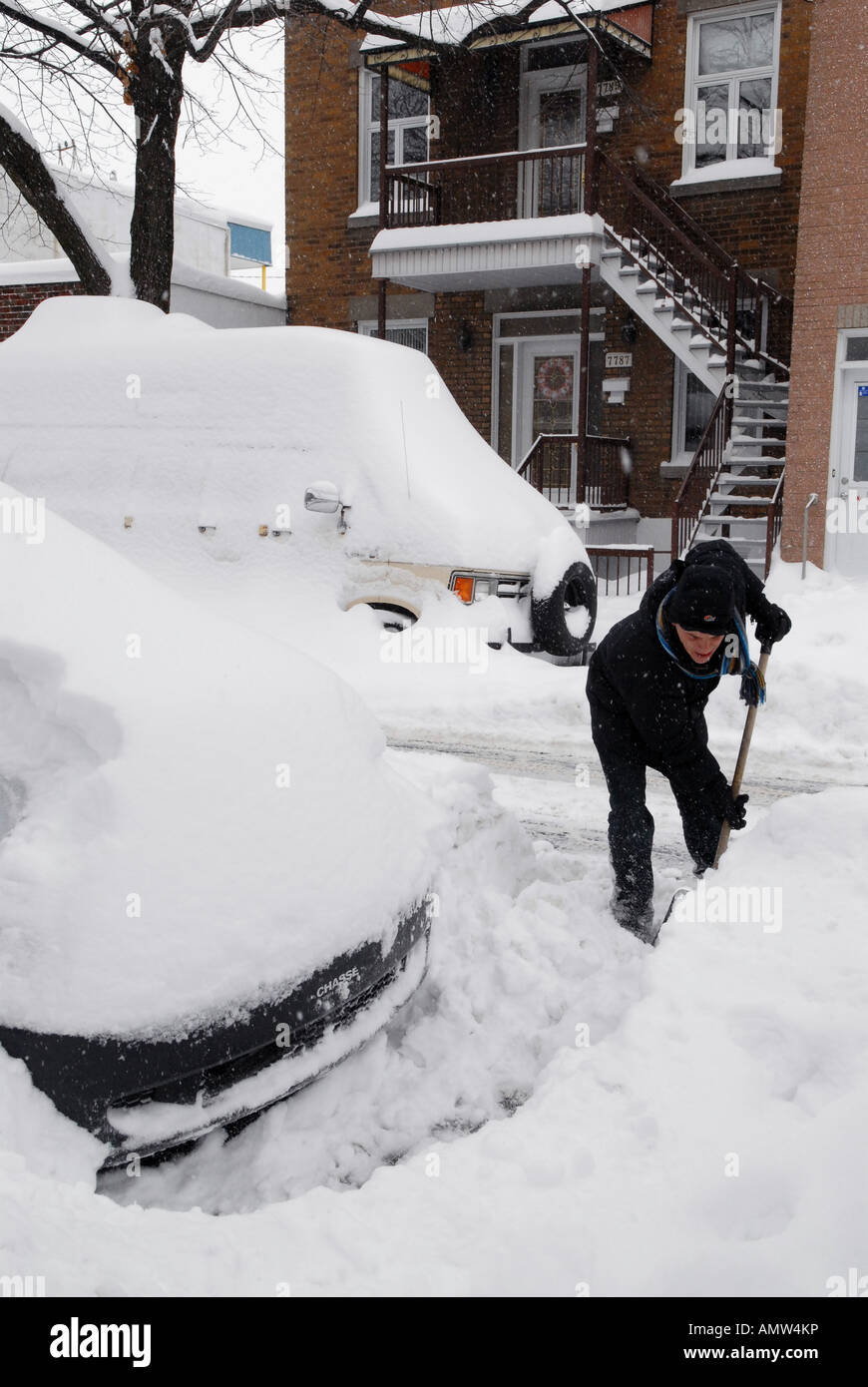 Man digging out car after a major snow storm in Montreal Quebec Canada ...