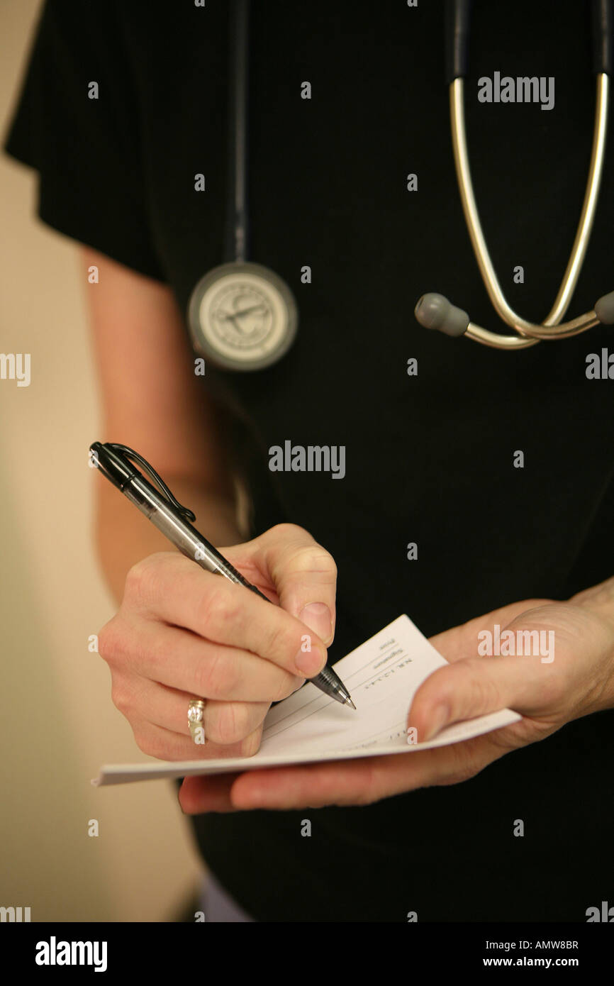 A doctor takes notes during a doctor patient session Stock Photo - Alamy