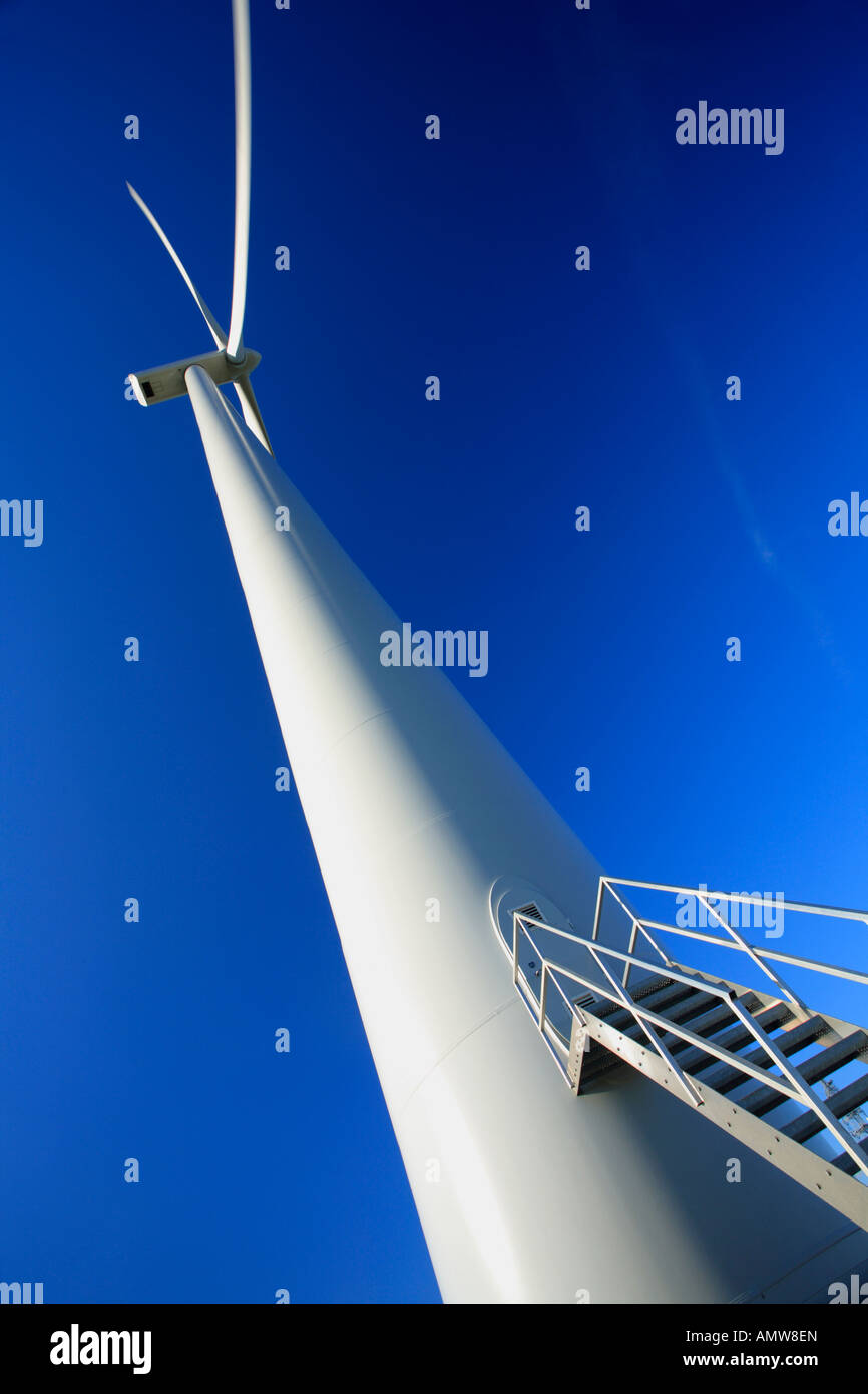 Looking up at a wind turbine, turning against a blue sky Stock Photo ...
