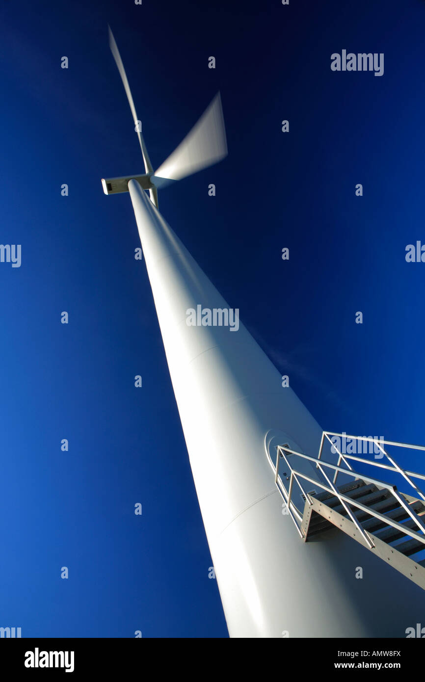 Looking up at a wind turbine, turning against a blue sky Stock Photo ...