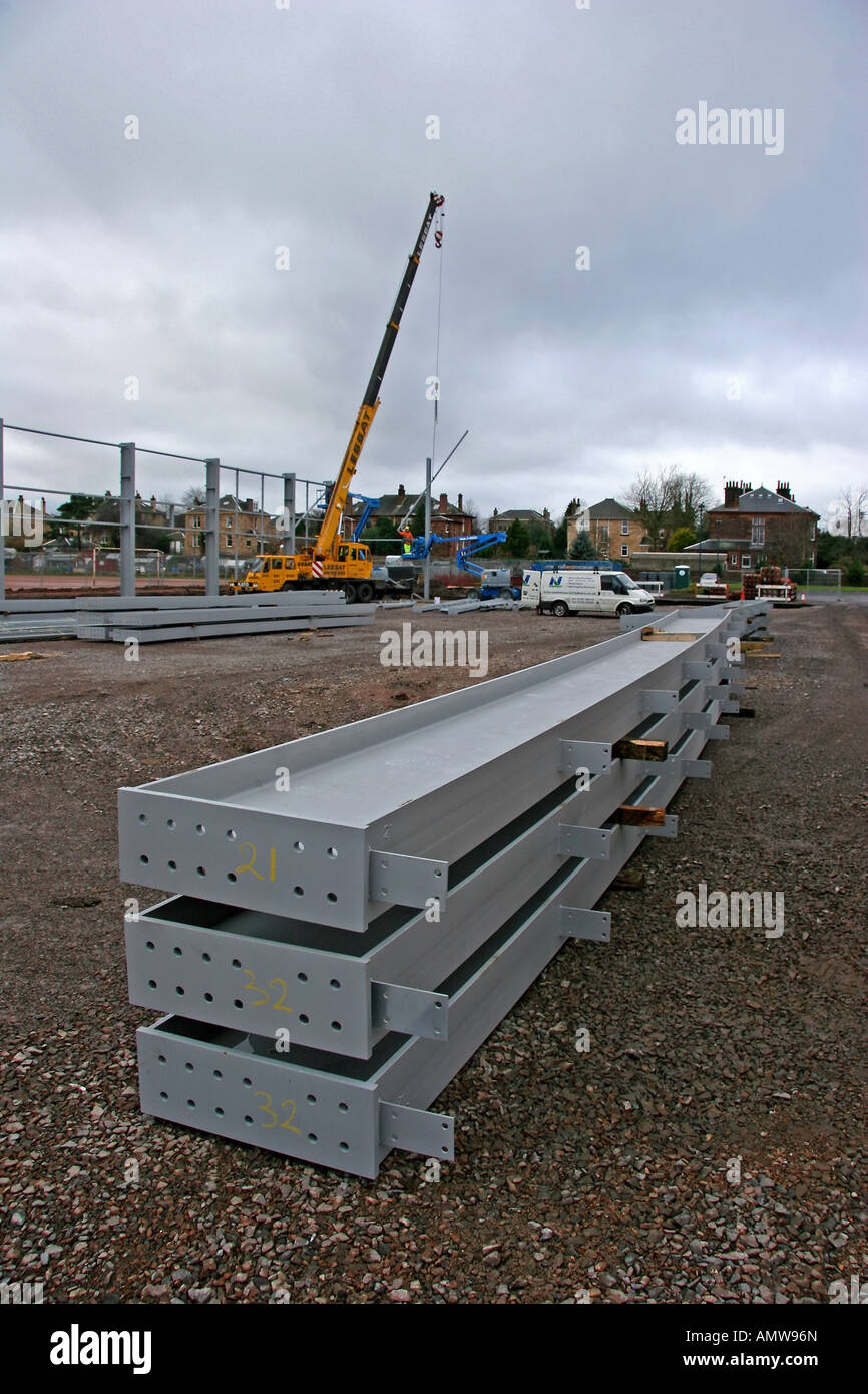 Crane lifting steel beams on construction site Stock Photo - Alamy