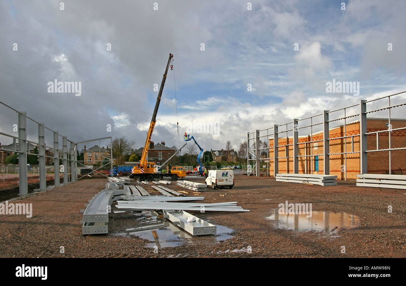 Crane lifting steel beams on construction site Stock Photo - Alamy