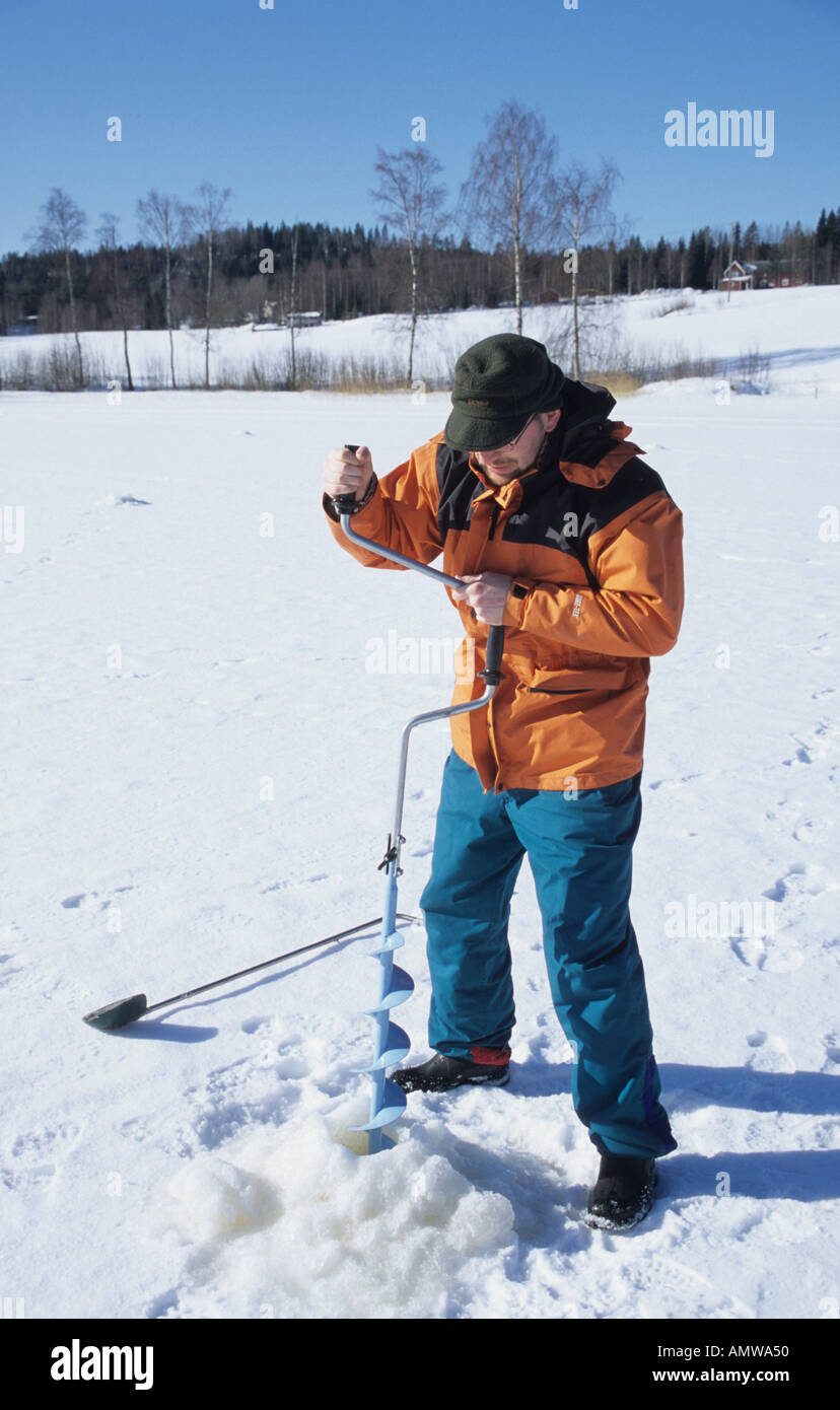 Man drilling hole in ice hi-res stock photography and images - Alamy