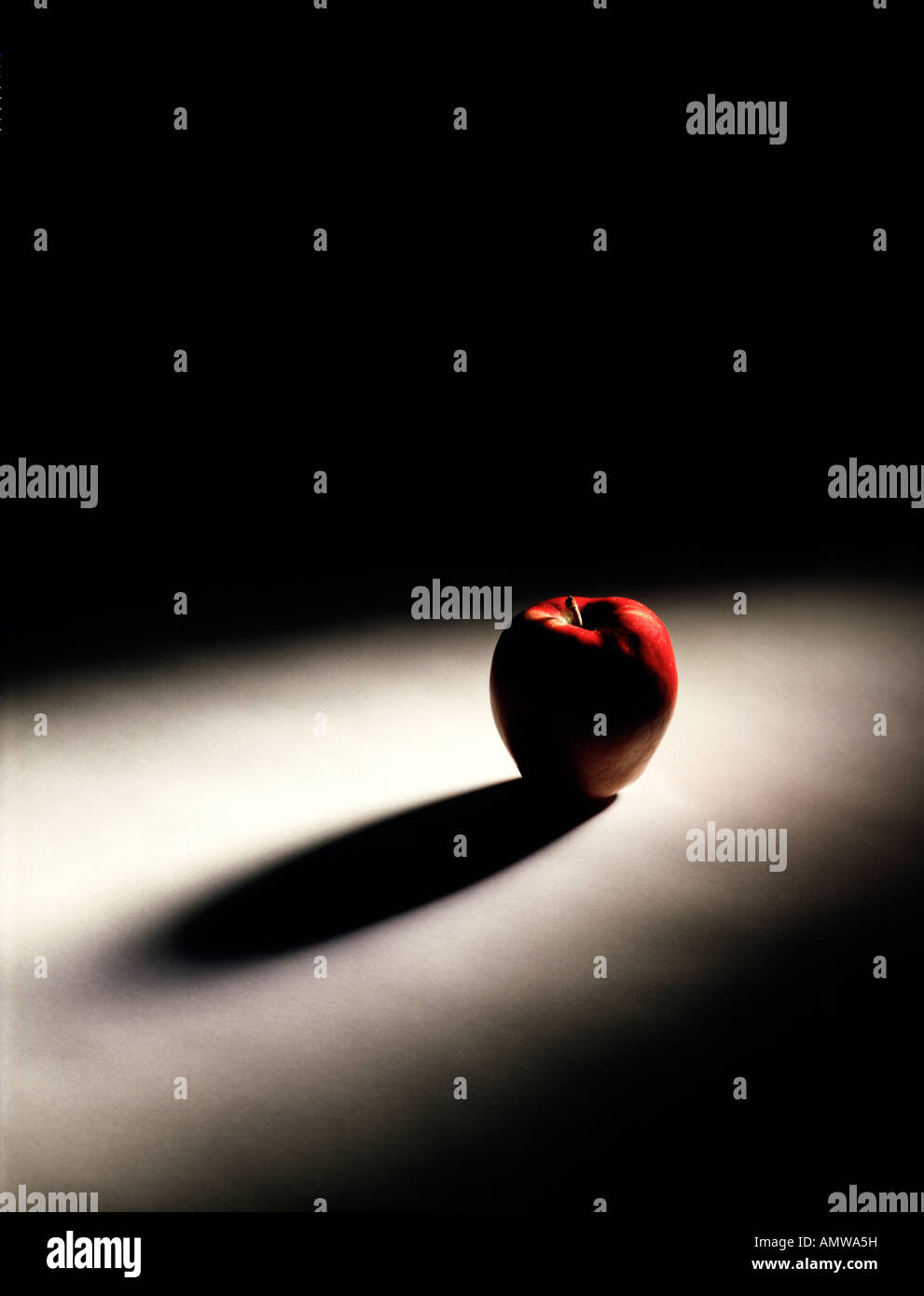An apple with a long shadow Stock Photo - Alamy