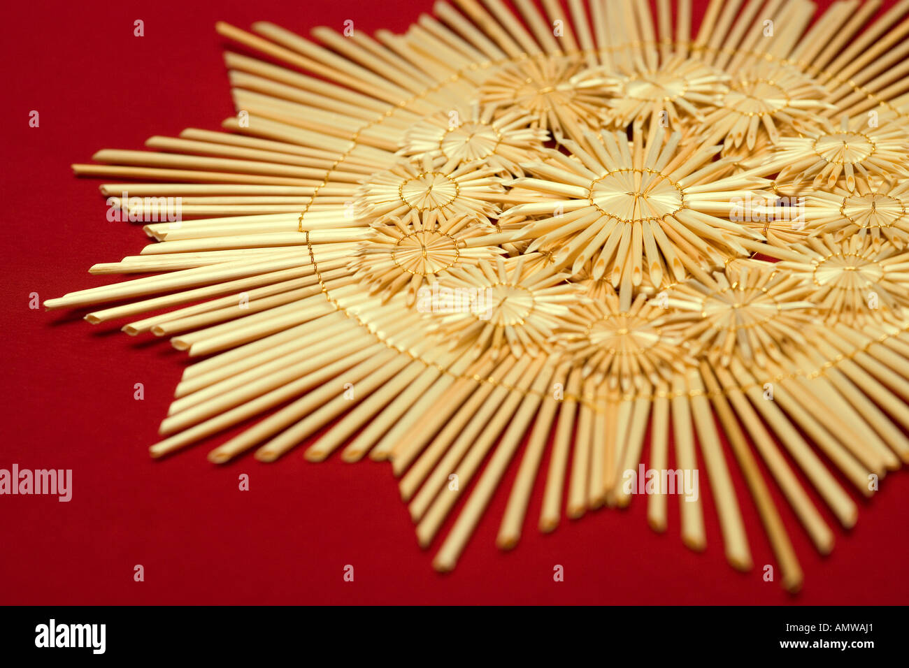 Straw star on red underground Stock Photo - Alamy