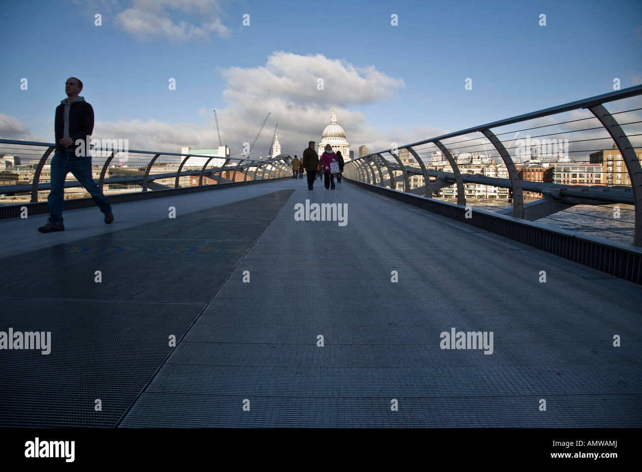 Pedestrians cross the Millennium Footbridge with St Paul's Cathedral in ...