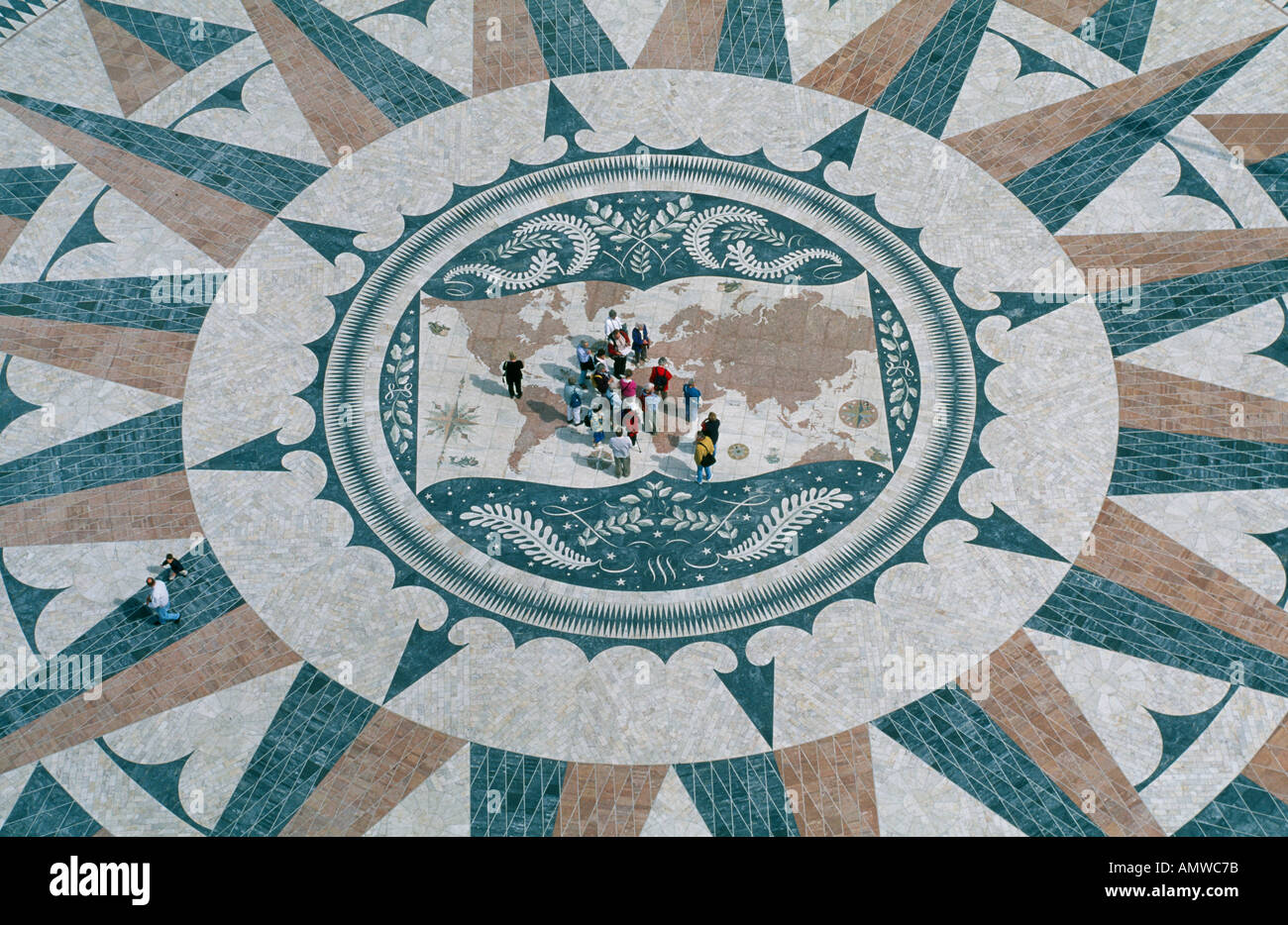 A group of tourists stand in the centre of the compass pavement in ...