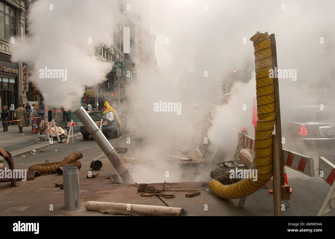 A broken steam pipe sends white clouds of steam into the cold Manhattan ...