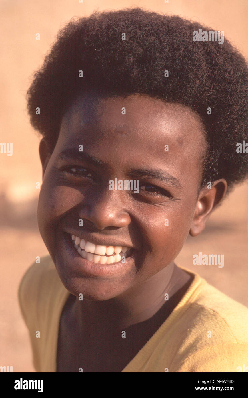 Smiling Ethiopian boy shows sophistication with well cut hair and neat ...
