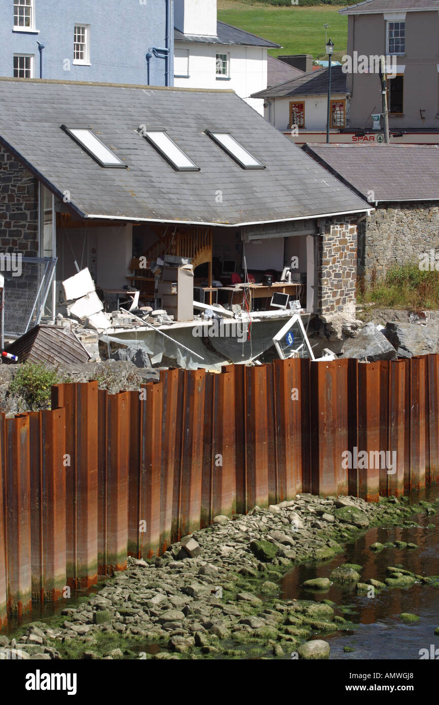 Building collapse alongside eroded river embankment River Aeron ...