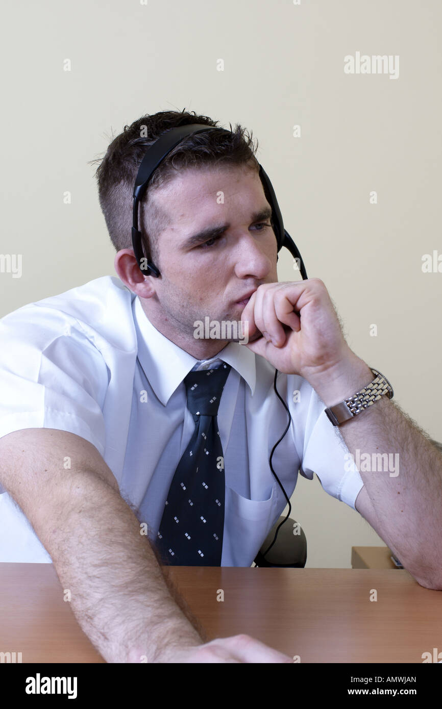 tired looking telesales worker Stock Photo - Alamy