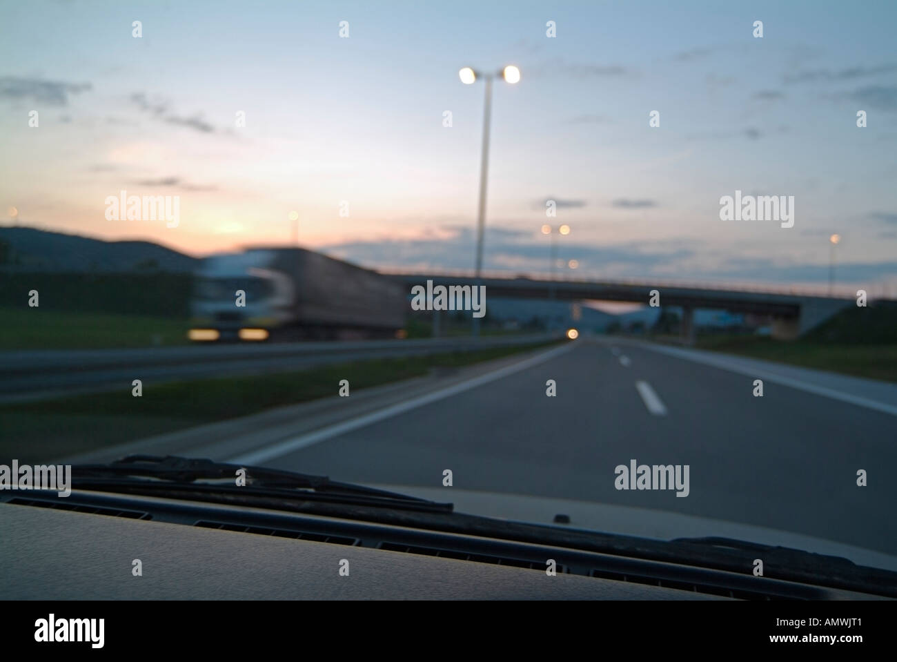 Drivers View from the Interior of a Car Driving at Dusk Along a ...