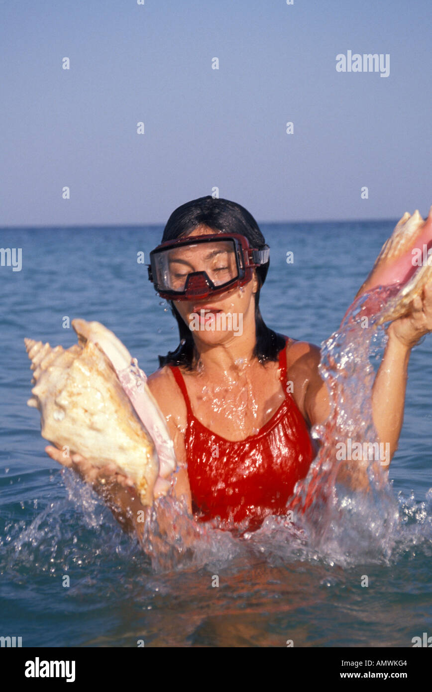 Caribbean island tropics woman with conch shells Stock Photo - Alamy
