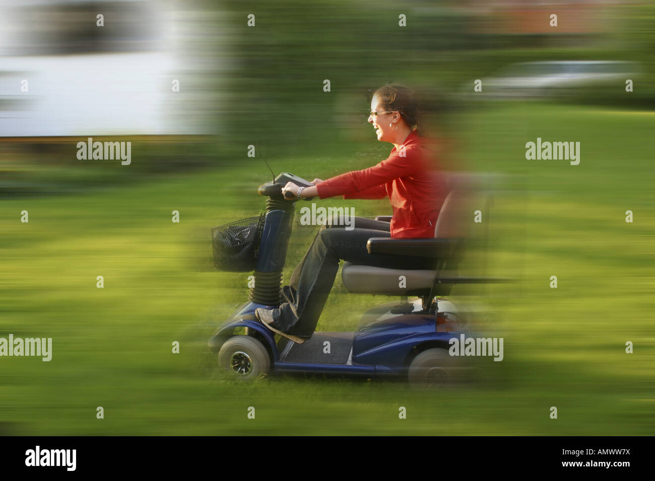 young woman riding with electric powered wheelchair in the garden Stock ...