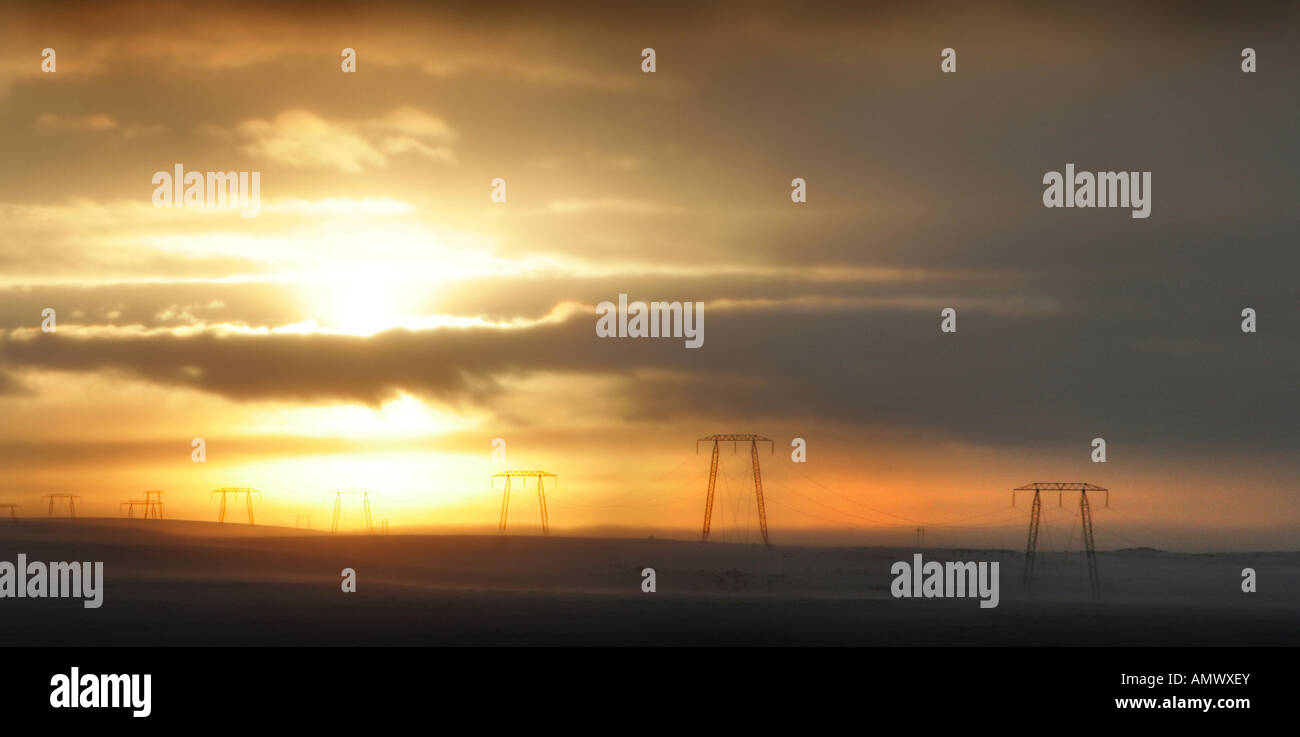Electrical pylons and sunset in Iceland Stock Photo - Alamy
