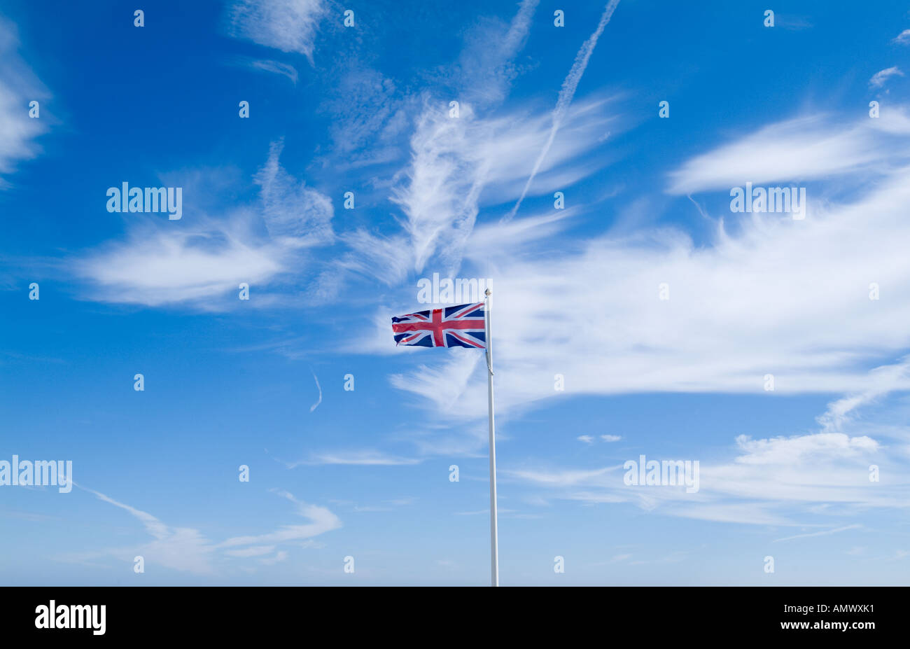 union jack flag flying against a blue sky Stock Photo - Alamy