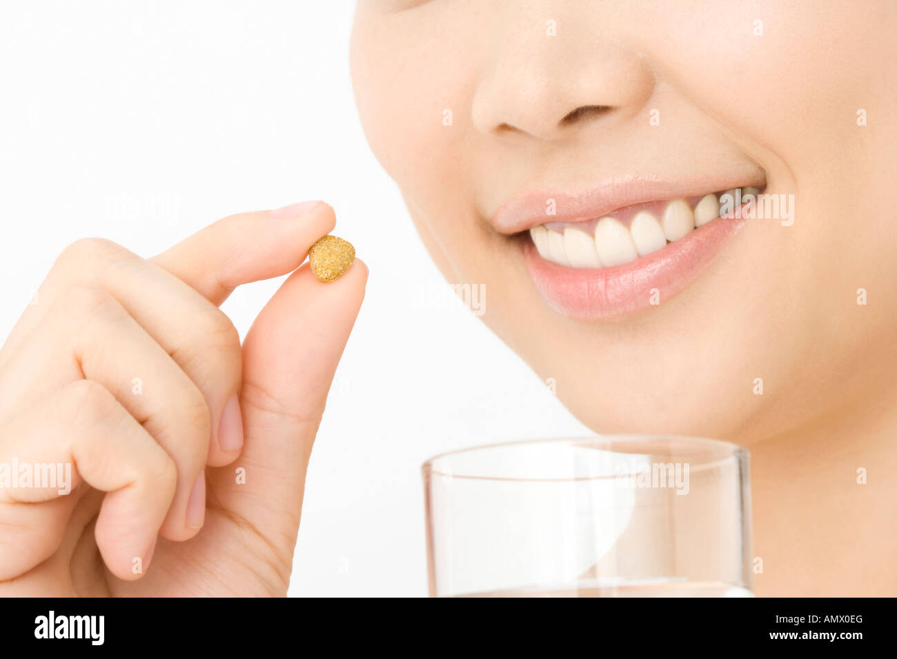 Woman who takes a supplement Stock Photo - Alamy