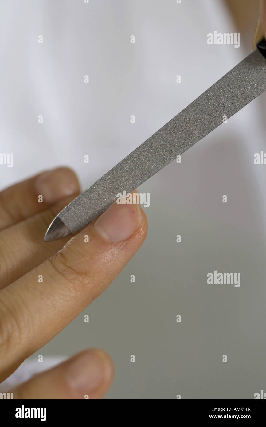 woman filing her nails Stock Photo - Alamy